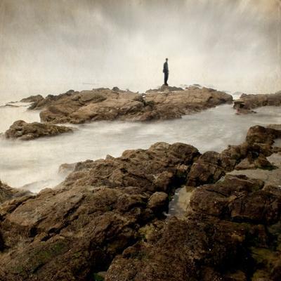 'A Lone Man Standing on Large Rocks with the Seas Swirling around Them ...