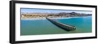 A long pier reaches out into the Pacific Coast in the quaint city of ...