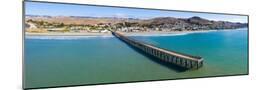 A long pier reaches out into the Pacific Coast in the quaint city of ...