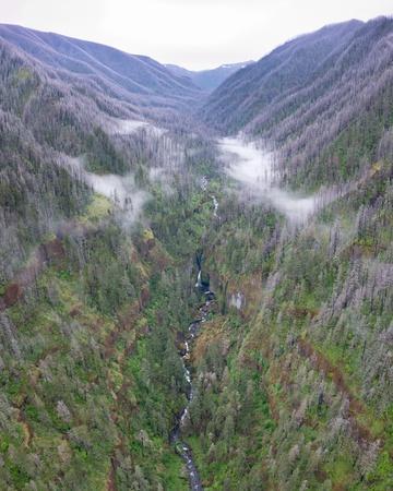 A scenic river flows through a slot canyon and into the Columbia River ...