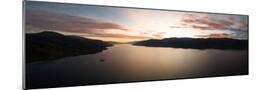 A serene sunrise illuminates Kalabahi Bay surrounded by the island of ...