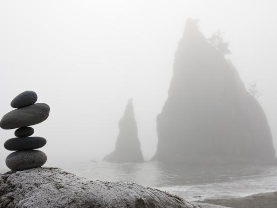 A Small Stone Cairn On Driftwood With Sea Stacks At Rialto Beach