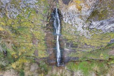 'A waterfall flows over a cliff into the Columbia River Gorge in Oregon ...