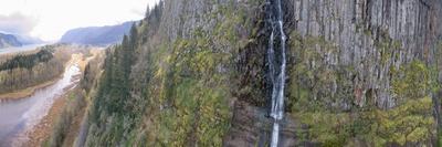 'A waterfall flows over a cliff into the Columbia River Gorge in Oregon ...