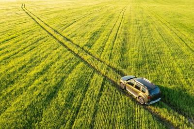 Aerial view of Renault Duster car SUV driving on countryside road in ...