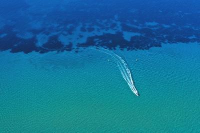 Aerial view of speed boat in motion. Water transportation and summer ...
