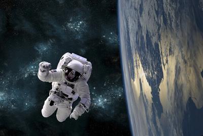 'An Astronaut Floating Above Earth' Photographic Print - Stocktrek ...