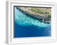 An extensive fringing reef grows along the edge of a remote island near ...