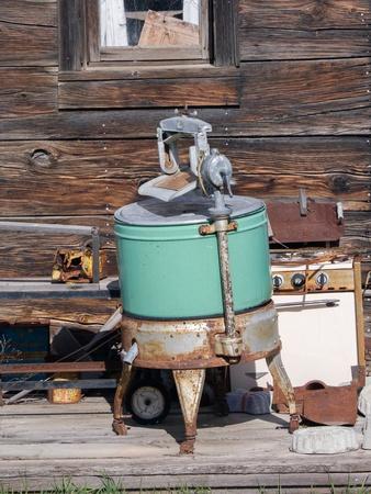 'An old washing machine and old rusty stove on the porch of a building ...