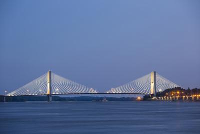 'Barge on Mississippi River and Bill Emerson Memorial Bridge at dusk ...
