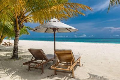 'Beautiful tropical beach. White sand and coco palms chairs, umbrella ...