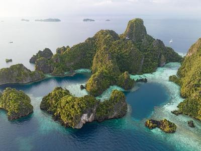 Coral reefs surround the dramatic limestone islands that have been ...