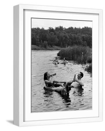'Couple Drinking Beer at Inner Tube Floating Party on the Apple River ...