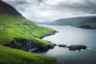 'Dramatic view of green hills of Vagar island and Sorvagur town on background. Faroe islands ...