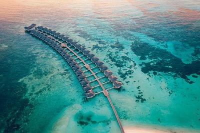 'Drone photo wooden water villas seen from above and an amazing blue ...