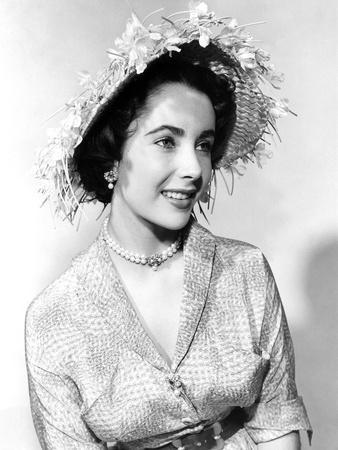 'Elizabeth Taylor, modeling a straw hat trimmed with light-blue sweet ...