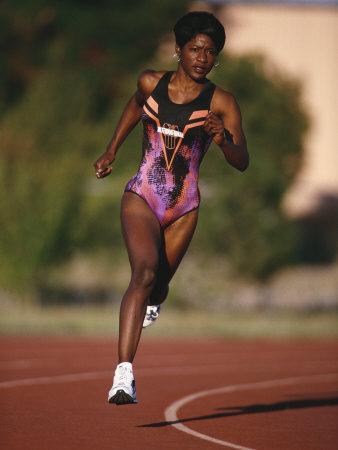 'Female Runner Competing in a Track Race' Photographic Print ...