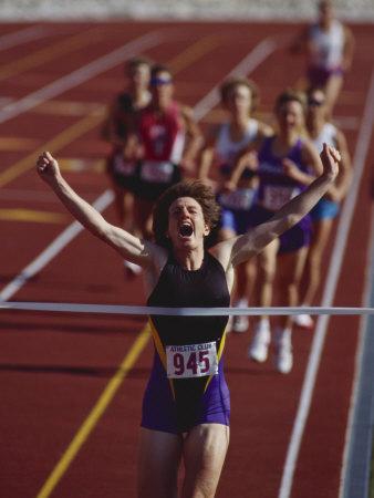 'Female Runner Victorious at the Finish Line in a Track Race ...