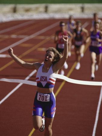 'Female Runner Victorious at the Finish Line in a Track Race ...