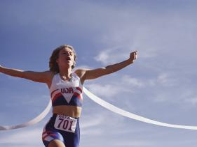 'Female Runner Victorious at the Finish Line in a Track Race ...