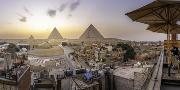 View of Giza Pyramids from rooftop terrace at sunset, Cairo, Egypt ...