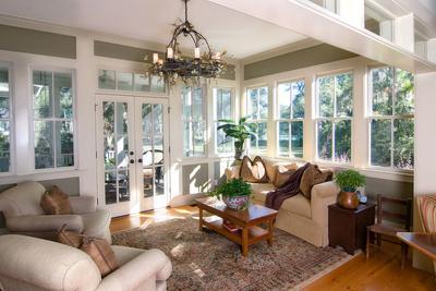 'Furnished Sunroom with Large Windows and Glass Doors' Photographic ...