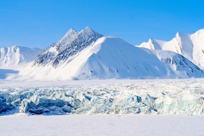 'Glacier front of Fridtjovbreen and the frozen fjord Van Mijenfjorden ...