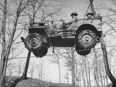 'Group of Us Soldiers Pulling a Jeep over a Ravine Using Ropes while on ...
