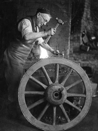 'Hammering a Wheel' Photographic Print | AllPosters.com