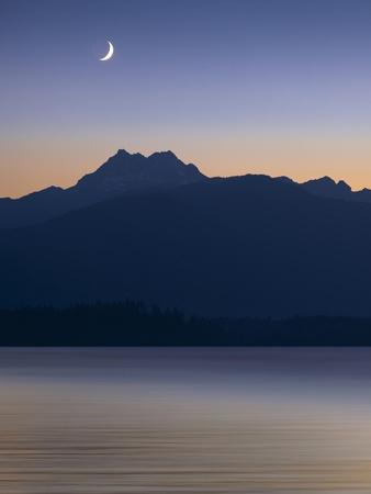 'USA, Washington State, Seabeck. Crescent moon at sunset over Hood ...