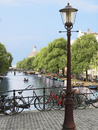 'Old Gas Lamp Post and Bicycles on a Bridge over a Canal in Amsterdam ...