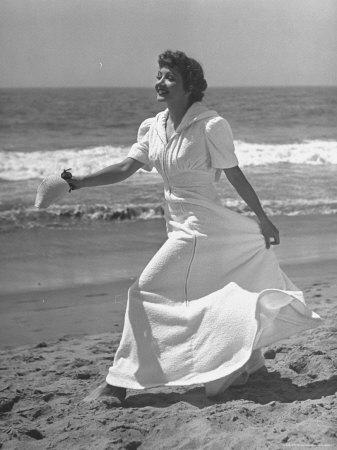 'Claudette Colbert in Zippered, Terry Cloth Beach Robe, Sashaying Along ...
