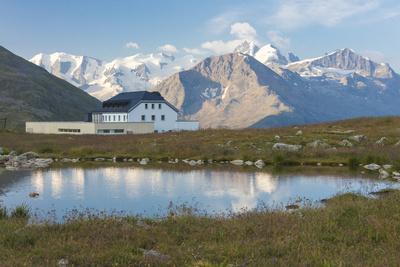 'The alpine lake frames the hotel surrounded by peaks, Muottas Muragl ...