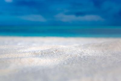 'Sandy beach and beautiful tropical sea on blue sky background. Summer ...