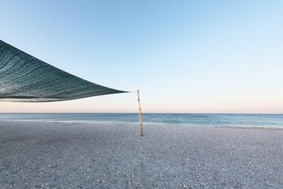 'Shelter from the sun on tropical beach sand and blue sea water ...