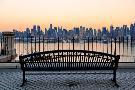 'Bench in Park and New York City Midtown Manhattan at Sunset with ...