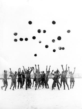 'Sport: Group of Men Throwing Bullets into the Air. Photograph around ...