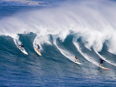 'Surfers Ride a Wave at Waimea Beach on the North Shore of Oahu, Hawaii ...