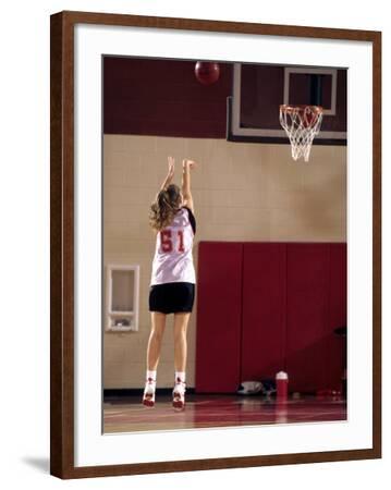 'Teenage Girl Practicing Basketball Indoors' Photographic Print ...
