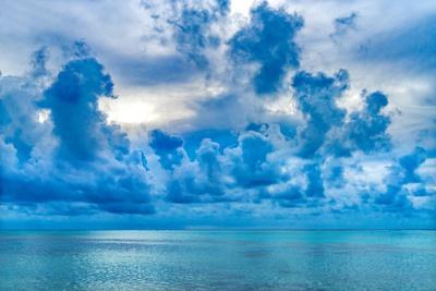 'Cloudscape, Moorea, Tahiti, French Polynesia. Blue colors in water in ...