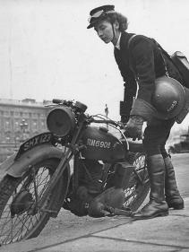 'Woman Dispatch Rider Standing Beside Her Motorcycle' Photographic ...