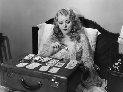 Woman Playing Cards in Bed Photo | AllPosters.com