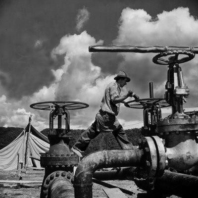 'Worker Opening up a Pipeline to Let the Oil Flow' Photographic Print ...