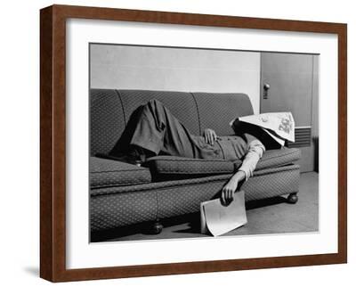 'Writer Niven Busch Lying on Sofa with Newspaper over His Face as He ...