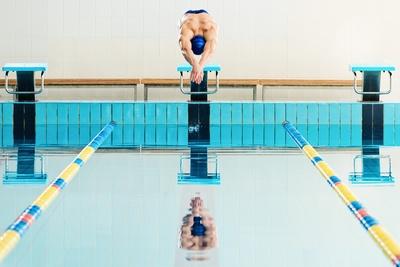 'Young Muscular Swimmer Jumping from Starting Block in a Swimming Pool ...
