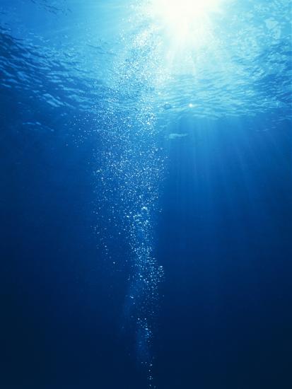 'Bright Light Shooting To Surface of Deep Blue Sea with Trail of ...