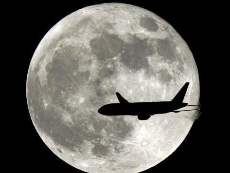 A Jet Plane Passes in Front of the Full Moon Above Surfside, Fla ...