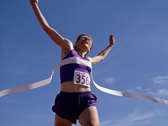 Female Runner Celebrates Victory at the Finish Line Photographic Print ...