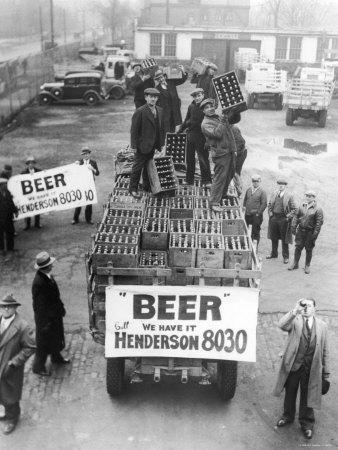 Men Atop Beer Delivery Truck Hoist Cases of Beer Triumphantly While Man ...